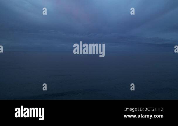 Minimalist aerial footage of still ocean waters blending into a ...