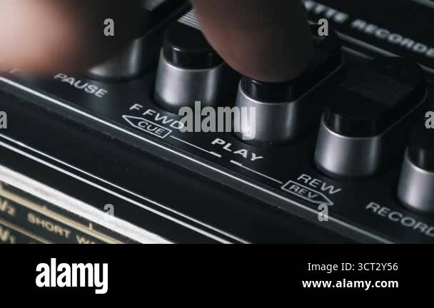 Angled close-up of a finger pressing the play and then stop eject ...