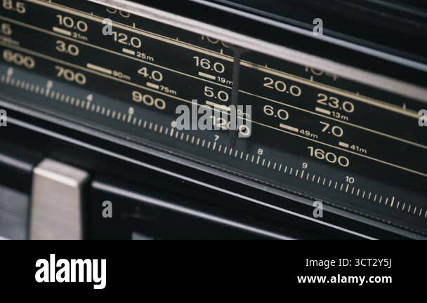 Angled macro of a radio tuner indicator moving across an analog ...
