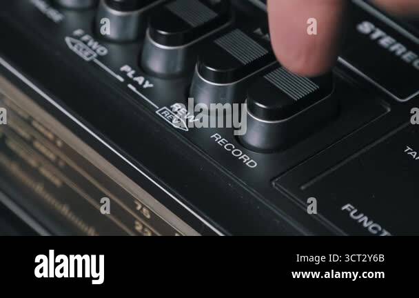 Macro side angle shot of finger pushing record control on vintage ...