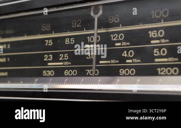 Macro shot of tuning a vintage radio, the indicator needle moving ...