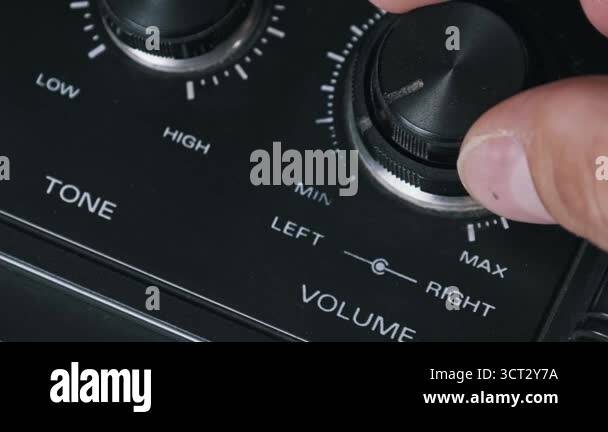Extreme close-up macro shot of thumb and finger turning a dusty volume ...