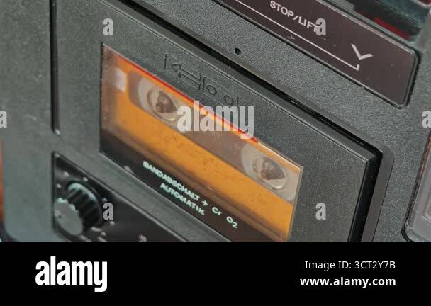 Close-up of hand opening deck and ejecting vintage audio cassette from ...