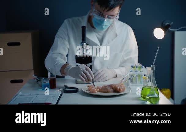 Young male nutrition expert testing food products in lab. Genetic ...