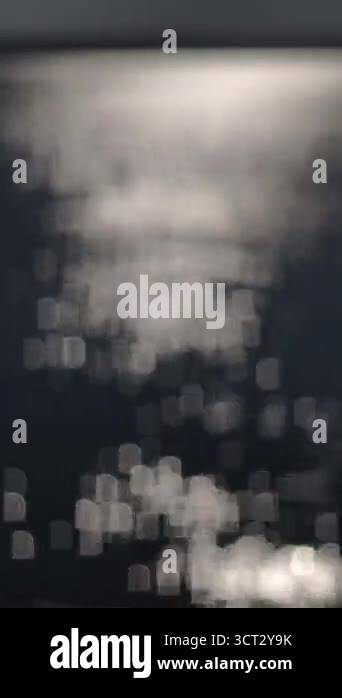 Vertical abstract shot of shimmering light reflecting on dark water ...