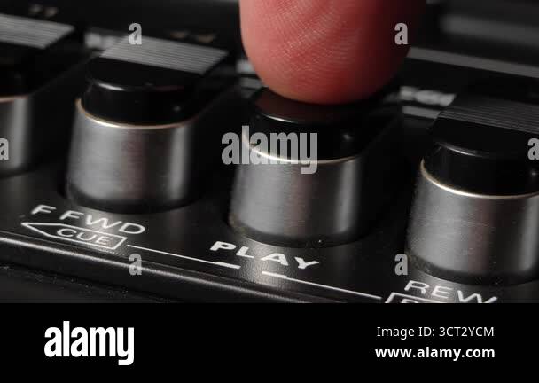 Extreme close-up of a finger pressing the PLAY button on a retro ...
