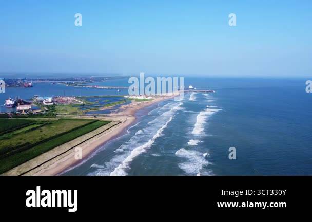 Drone shot of general cargo ship incoming port near a beach 4K stock ...