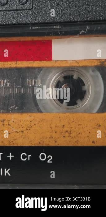 Extreme close-up vertical video of vintage cassette tape reel spinning ...