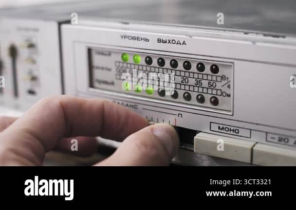 Close-up of hand adjusting balance fader on a Soviet amplifier ...