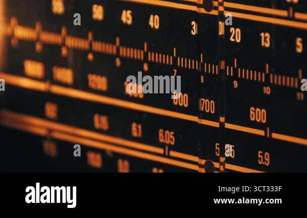 Macro shot of a vintage radio tuning dial indicator moving across the ...