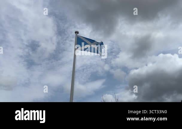 Scotland - A Scottish Saltire flag flutters in the wind against a clear ...