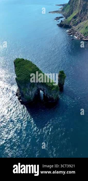 Captivating view of dramatic volcanic rock formations Drangarnir rising ...