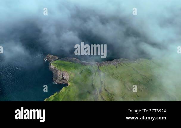Explore the stunning coastal cliffs of the Faroe Islands, enveloped in ...
