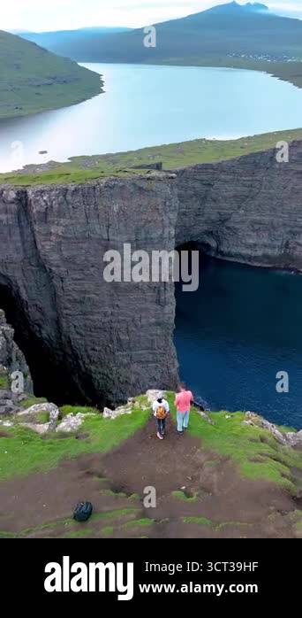 Explore the stunning cliffs overlooking deep blue waters in the Faroe ...
