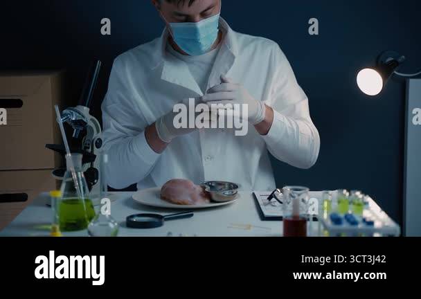 Genetically modified meat. GMO food concept. Genetic injection. Food scientist injecting raw ...
