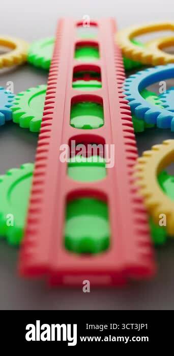 Vivid 3D loop of colorful plastic gears and racks in red, yellow, green ...