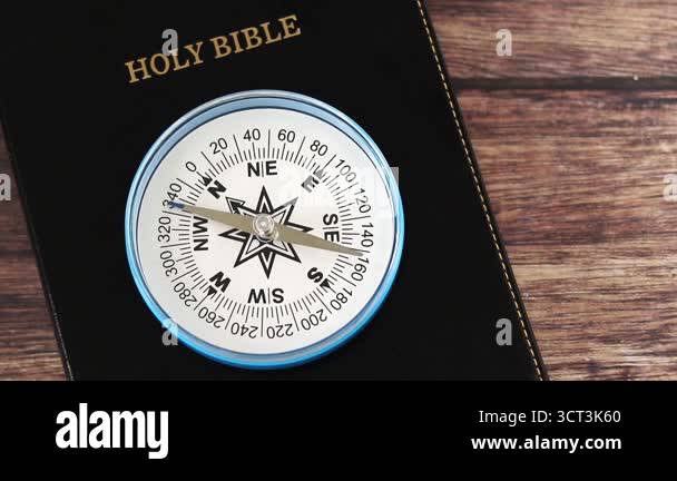 Compass on Christian holy bible book. Spiritual journey and guidance ...