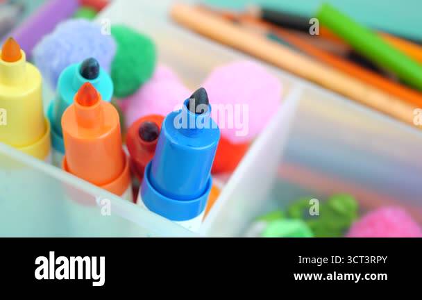 Bright markers and crafting materials arranged neatly for creative ...