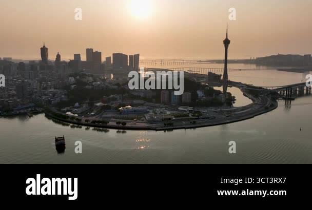 panoramic view of the Macau cityscape at sunset, featuring the ...