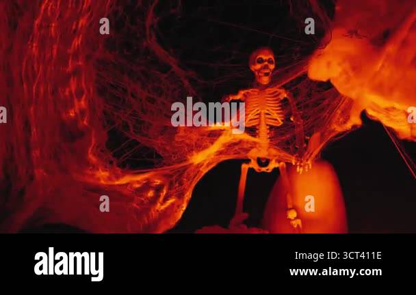 Shaking Skeleton Figure in a Web. Creepy Halloween Decor in flashing ...