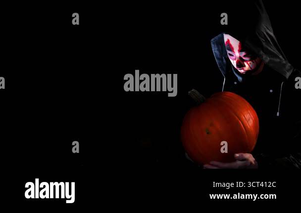Halloween atmosphere.Bloody mask monster in a raincoat with a huge ...