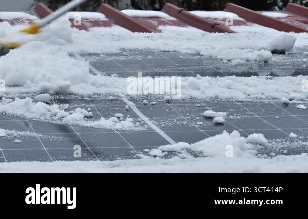 Cleaning solar panels during the winter season.Snow removal from solar ...