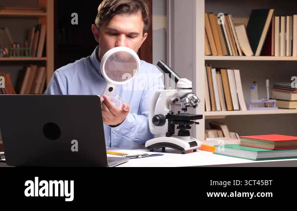 Close-up portrait scientist carefully examining sample with magnifying ...
