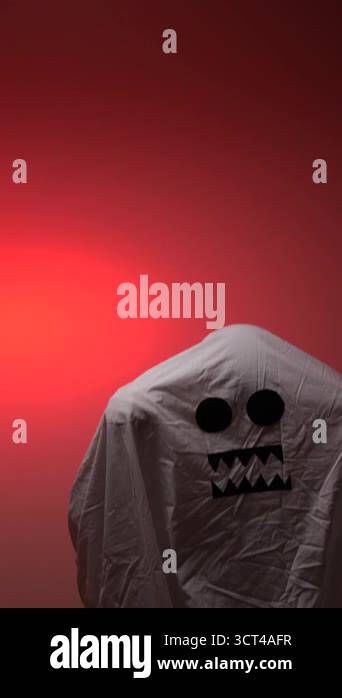 vertical video Spooky ghost costume with black eyes and jagged mouth ...