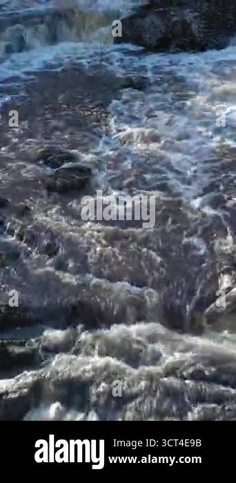 Aerial shot of rapids on a sunny day. River flowing between rocks ...