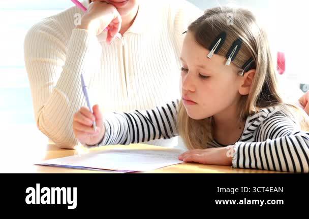 Mom teaches her daughter to write words, help with school homework ...