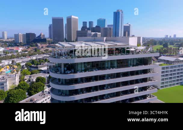 Cinematic aerial footage of a luxury rooftop terrace with glass ...