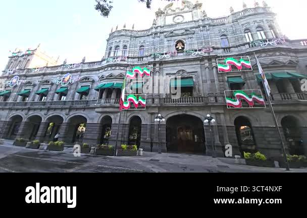 Grand government building decorated with Mexican flags, featuring ...