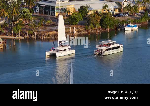Drone footage captures boats navigating a tropical marina in Port ...