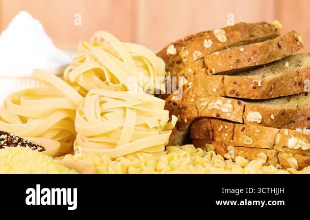 A variety of grains and sliced bread arranged in a well-lit setting ...