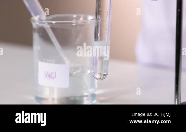Test tube and beaker in laboratory setting Stock Video Footage - Alamy
