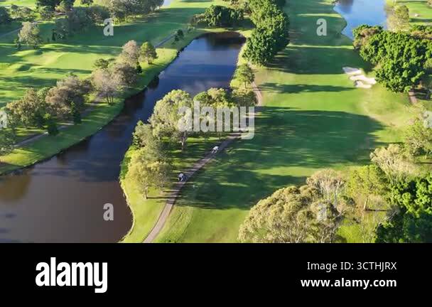 Drone footage captures a scenic golf course with lush greenery and ...