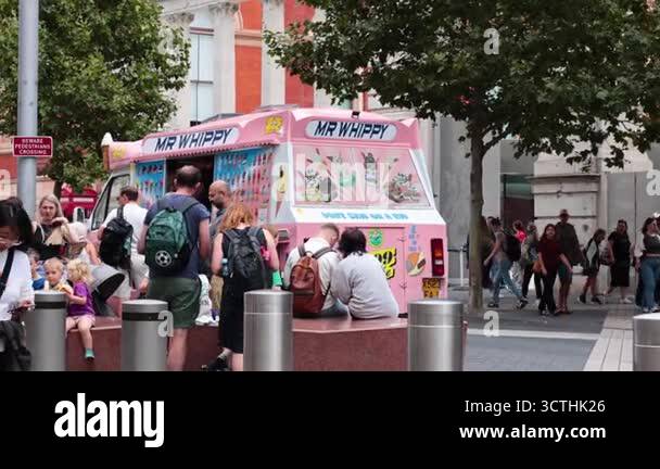 People gather around ice cream truck in London Stock Video Footage - Alamy