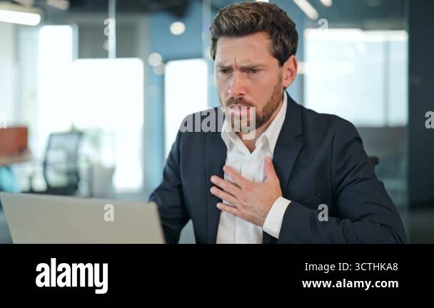 Anxious professional businessman in a suit experiences sudden chest ...