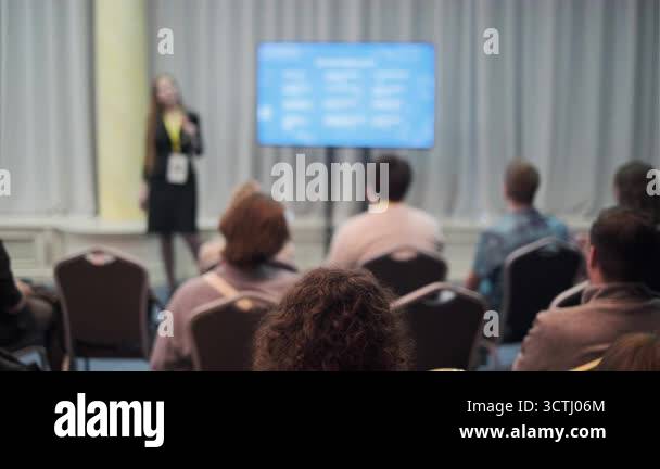 Business conference session with speaker addressing attentive audience ...