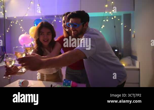 Friends celebrating birthday party in their home, having fun ...