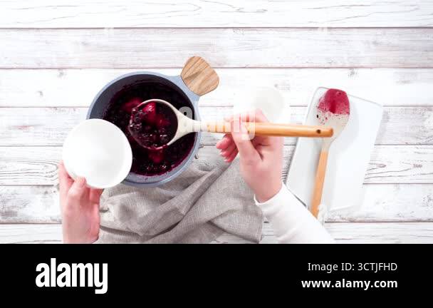 Flat lay. Homemade mix berry compote in small white bowls on a wooden ...