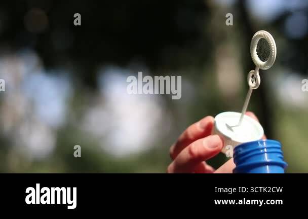 Unrecognizable girl blowing soap bubbles. Soap bubbles close-up ...