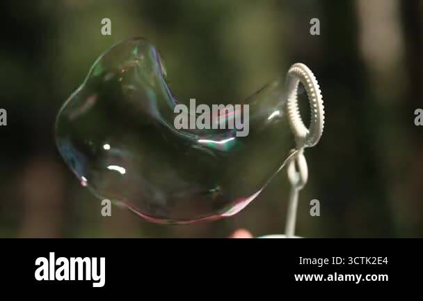 Unrecognizable girl blowing soap bubbles. Soap bubbles close-up ...