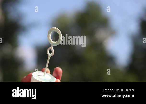 Unrecognizable girl blowing soap bubbles. Soap bubbles close-up ...