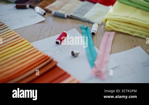 Colorful palette fabric samples with sewing tools lying on table ...