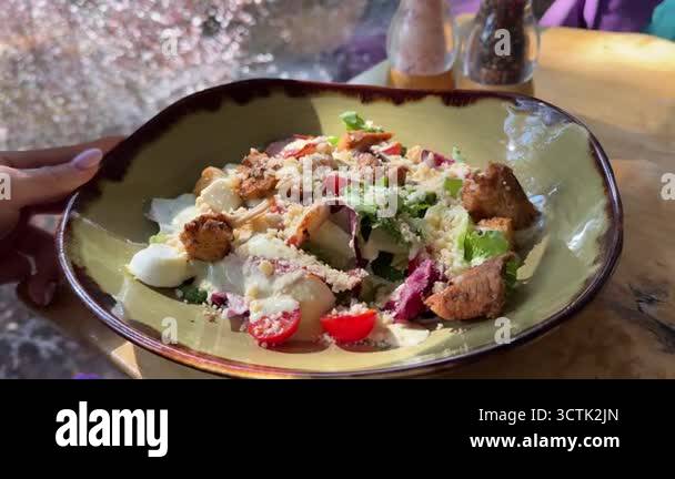 Caesar salad Fresh mixed salad with sesame seeds rotating slowly in ...