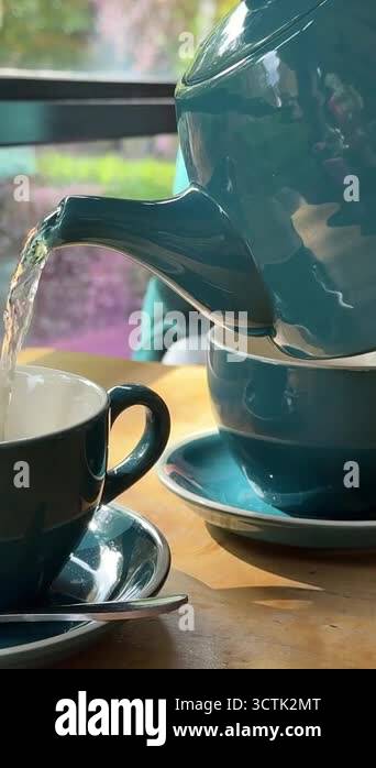 cozy restaurant woman pours tea In emerald green cup autumn Cold Warmth ...