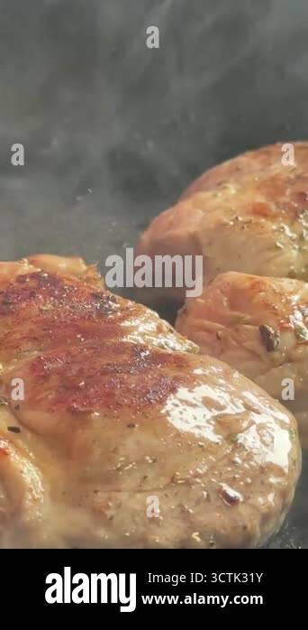 two large steaks are grilled with a lot of smoke pork neck turn meat ...