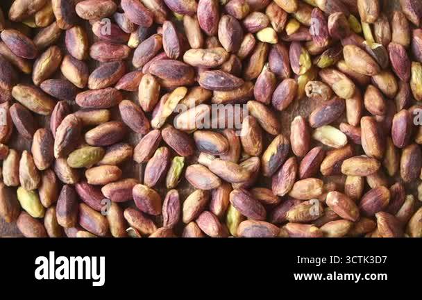 slow motion of pistachios dropping on a table, top view Stock Video ...