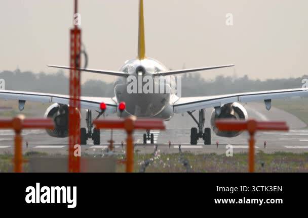Rear view of a commercial airliner on the runway, symbolizing aviation ...